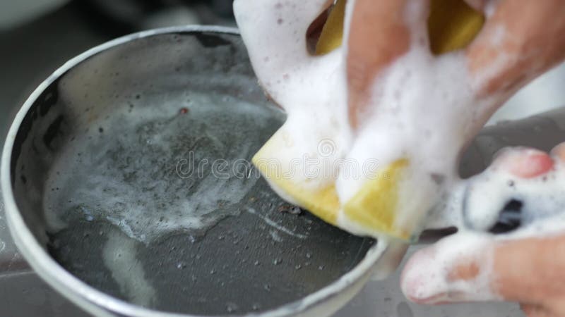 Hand washing a cooking pan stock footage. Video of sink - 277596042