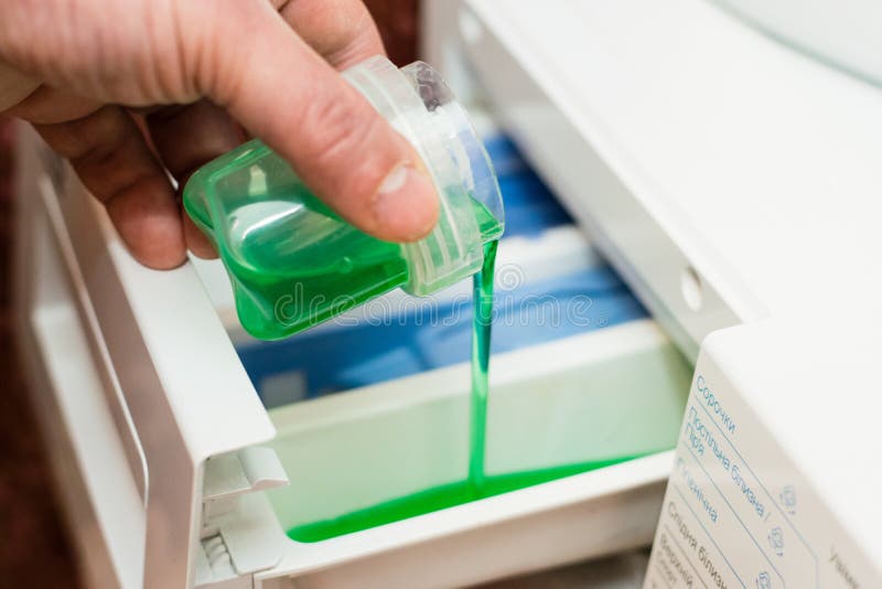 Hand with Washing Gel Close Up. a Man Pours Laundry Gel into the ...