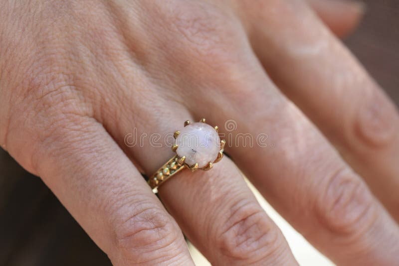Hand Wearing Brass Ring with Shiny Moonstone Gemstone Stock Photo ...