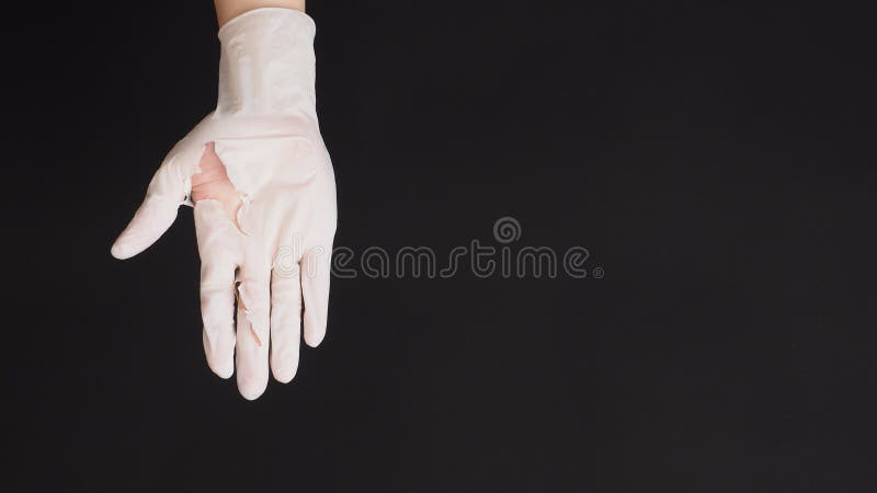 Hand Wearing Torn Latex Glove or Torn Rubber Gloves on Black Background ...