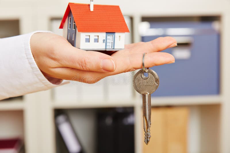 Hand holds house with key stock image. Image of idea - 142323371
