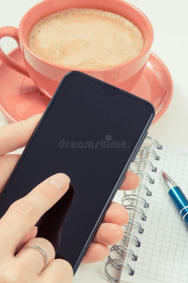 Hand of Woman with Mobile Phone, Coffee with Milk and Notepad for ...