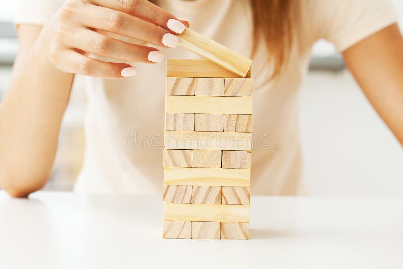 Hand of Woman Playing a Blocks Wood Tower Game Jenga Stock Photo ...
