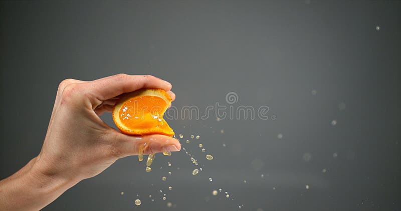 Hand of Woman Squeezing Orange Against Black Background Stock Image ...