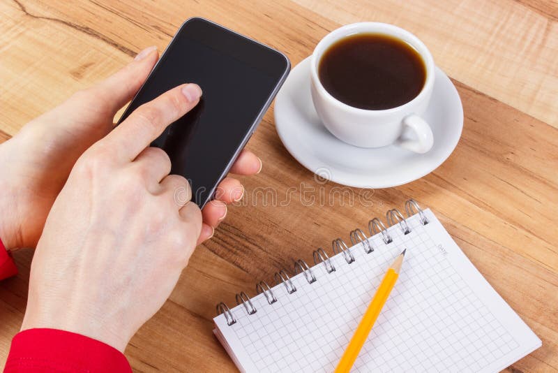 Hand of Woman Using Mobile Phone, Notepad for Writing Notes, Cup of ...