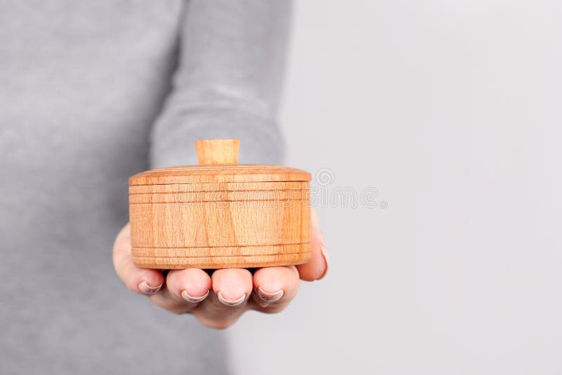 Hand with Wooden Container on Grey Background Stock Photo - Image of ...