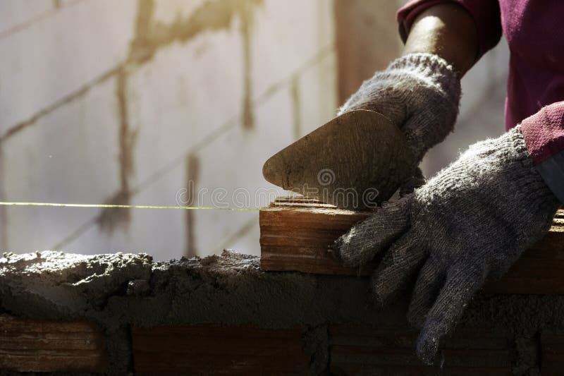 Hand of Worker Installing Bricks on Construction Site Stock Image ...