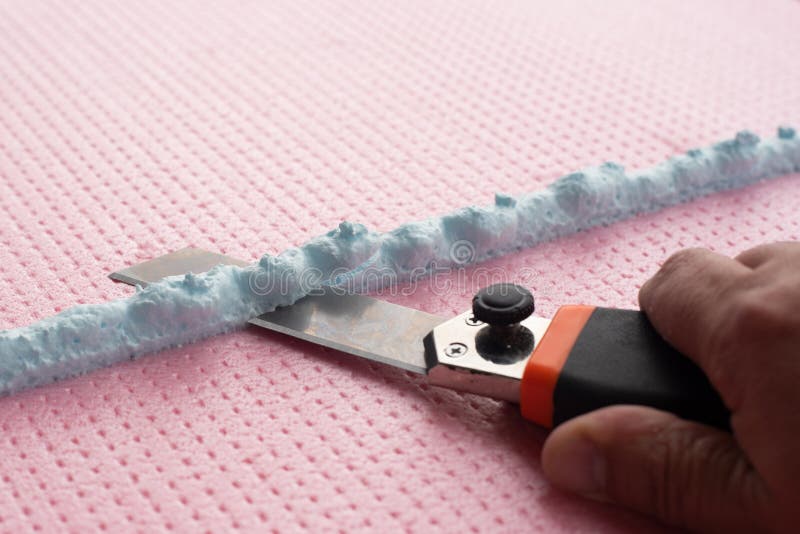 The Master with a Knife Cuts Off Excess Construction Foam Stock Photo ...