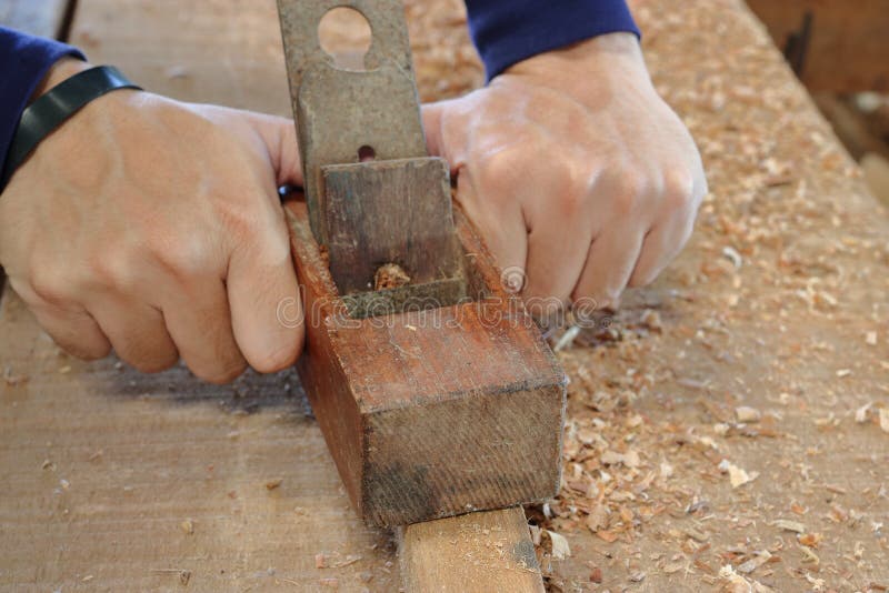 Hand Of Worker Planing A Plank Of Wood Using A Hand Planer Stock Image ...