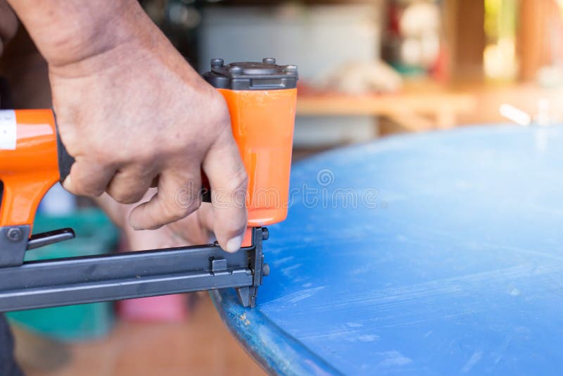 Hand of a Worker is Using a Nail Gun Stock Photo - Image of molding ...