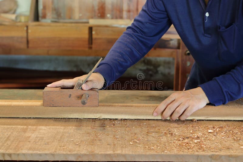 Hand of Worker Working with a Hand Planer on a Plank of Wood. Stock ...