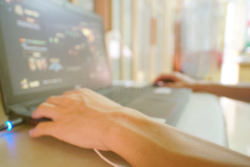 Hand is Working or Gaming by Laptop Computer on Desk at Private Area ...