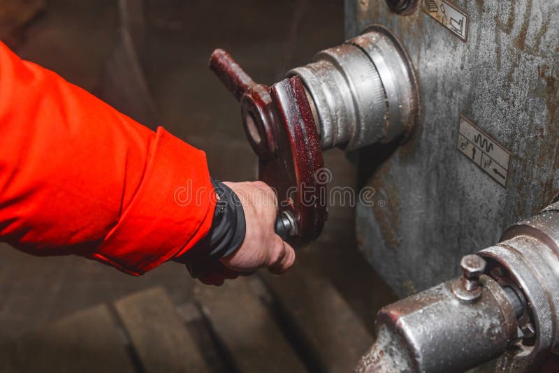 The Hand of a Working Man in Construction Clothes Holds the Handle and ...