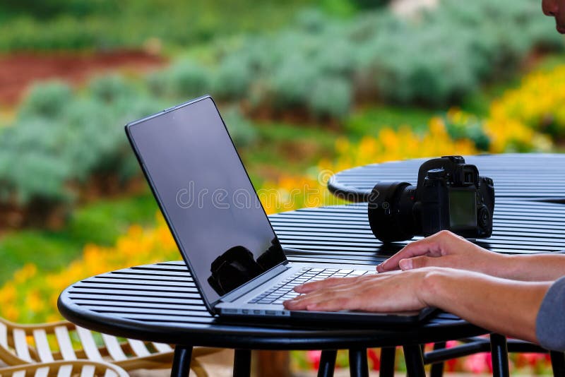 Hand Working on Notebook in the Flower Garden. Stock Photo - Image of ...