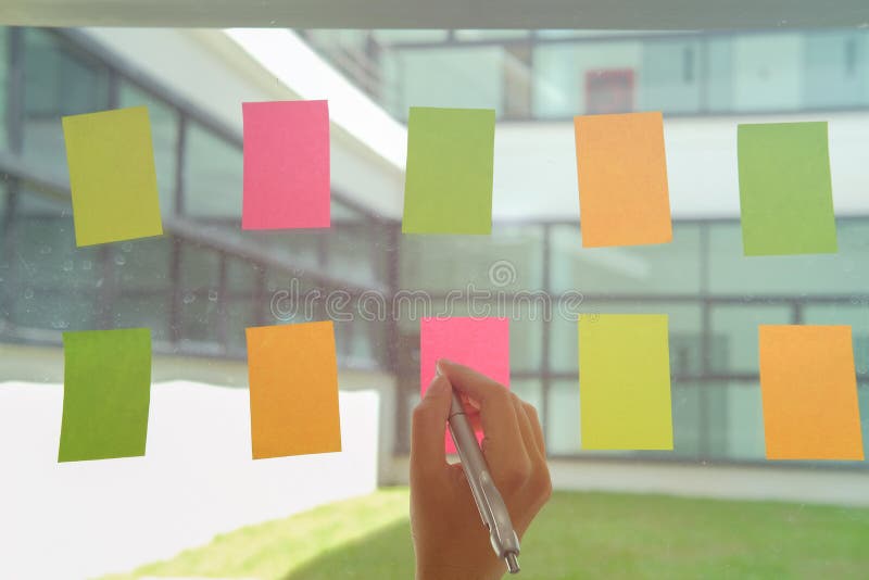 Hand Write on Adhesive Notes on Glass Wall. Sticky Note Paper Re Stock ...