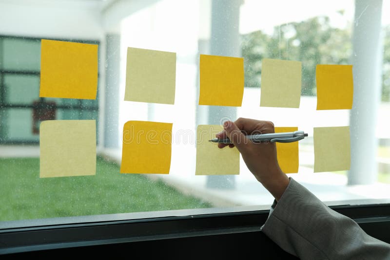 Hand Write on Adhesive Notes on Glass Wall. Sticky Note Paper Re Stock ...