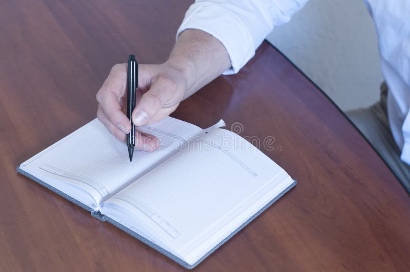 Hand Writes in an Open Notebook on a Desk. Businessman. Stock Photo ...