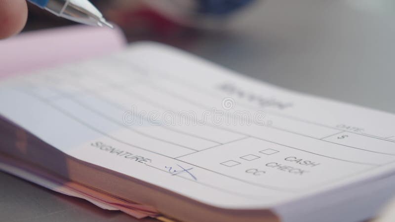 Writing on a Receipt at a Table in a Cozy Cafe Environment Stock Video ...