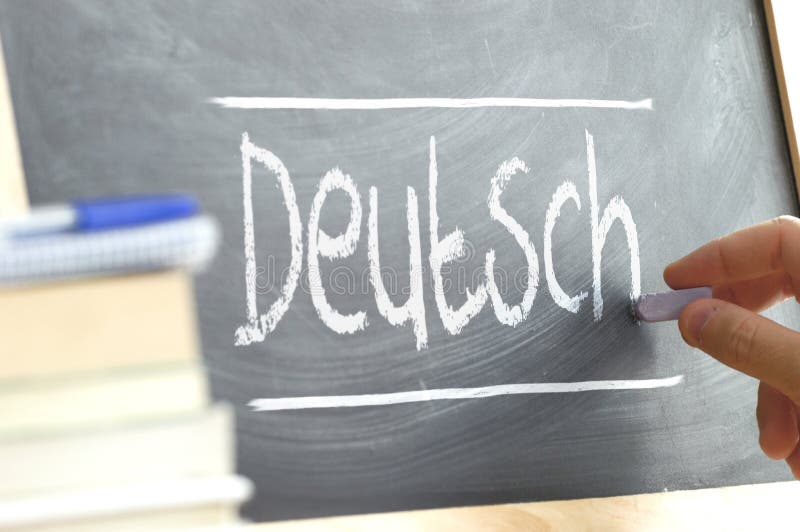 Hand Writing on a Blackboard in a Language Class with the Word "German ...