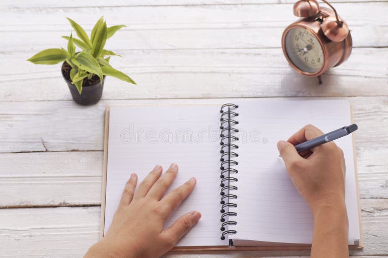 Hand Writing with Books and Clock on Desk Stock Photo - Image of ...