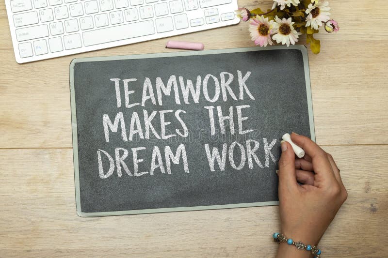 Hand Writing Hands Holding a Chalkboard with Teamwork Makes the Dream ...