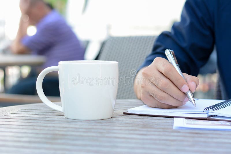 Hand Writing on Notebook with Coffee Cup beside Stock Image - Image of ...