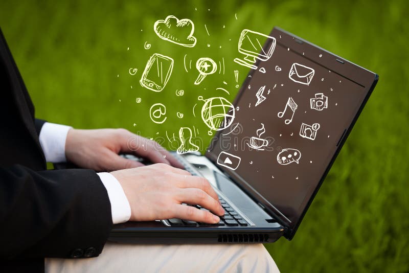 Hand Writing on Notebook Computer with Media Icons and Symbols Stock ...