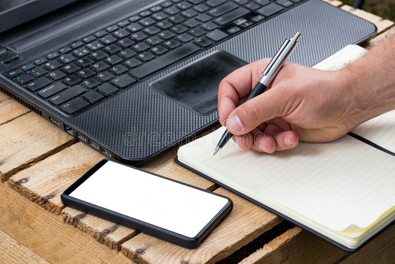 Hand Writing in a Notepad with Laptop and Smartphone Stock Photo ...