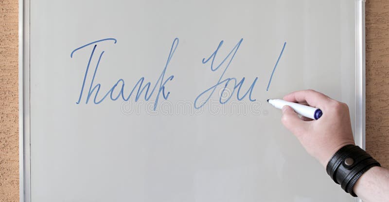 Hand Writing the Words THANK YOU on White Blackboard Stock Image ...