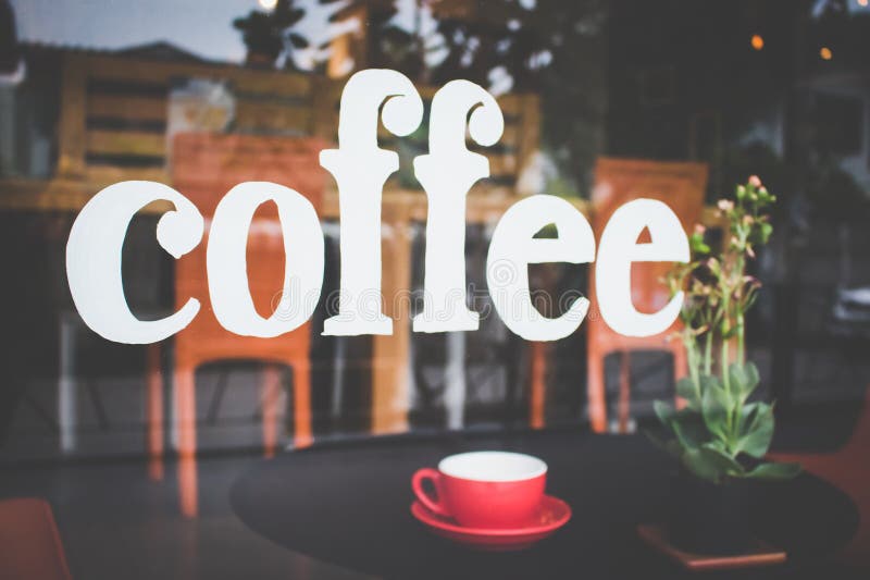 Hand Written Coffee at Glass of Cafe with Cup of Coffee or Te Stock ...