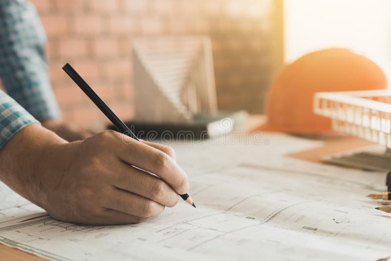 Hand of Young Engineering Man Drawing on Blueprint. Stock Image - Image ...
