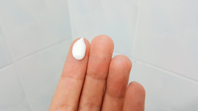 Hand of Young Man with Cream on Finger in the Bathroom, on White ...