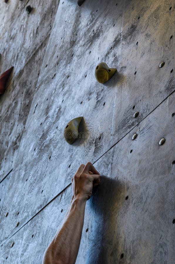 Hand of the Young Man on a Hook of the Artificial Climbing Wall Stock ...