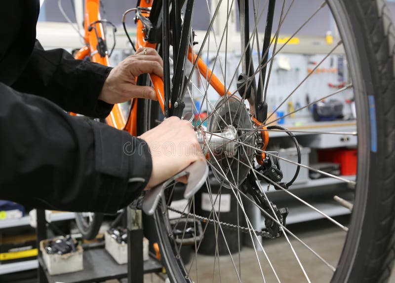 Hand of the Young Mechanic while Fixing the Bicycle Stock Photo - Image ...
