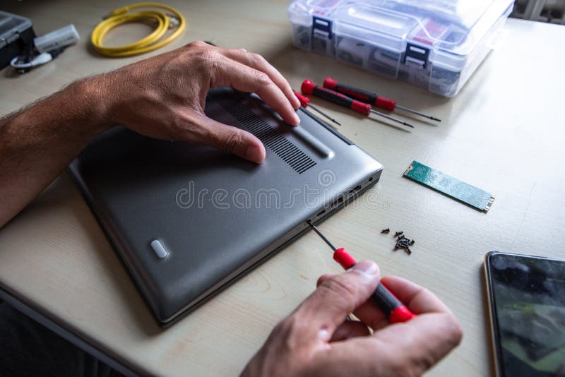 The Hand of a Young Serviceman Man Opening a Laptop Computer with a Red ...
