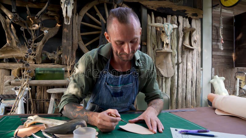 Handcrafted Leather Worker Sits Cowhide with Cutter According Pattern ...