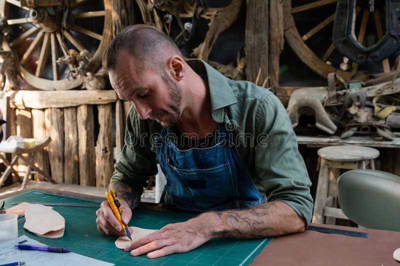 Handcrafted Leather Worker Sits Cowhide with Cutter According Pattern ...