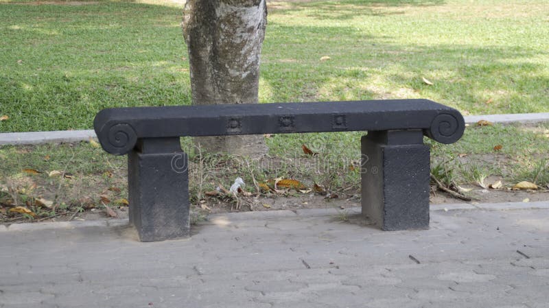 Handcrafted Old Black Stone Bench with Intricate Scroll Design in a ...