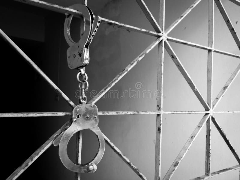 Handcuff Shackle on Steel Cage in Front of the Dark Way Stock Photo ...