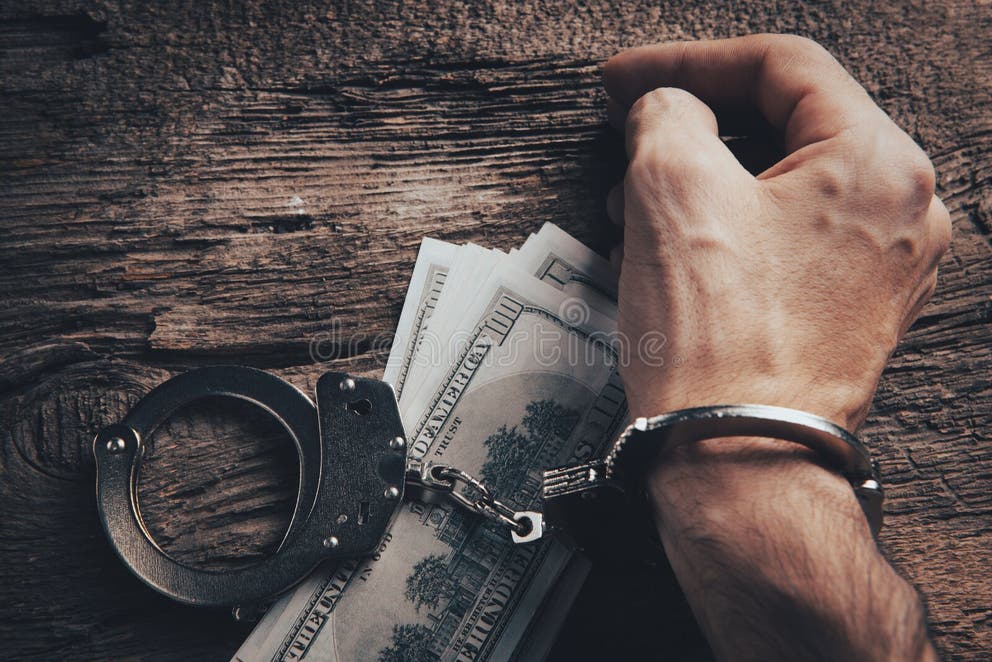 Handcuffed at the Table with Money Stock Photo - Image of punishment ...