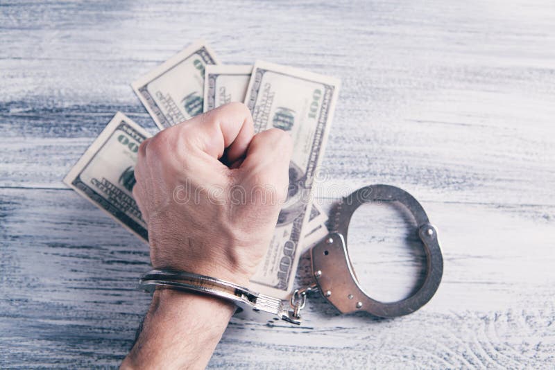 Handcuffed at the Table with Money Stock Image - Image of prisoner ...