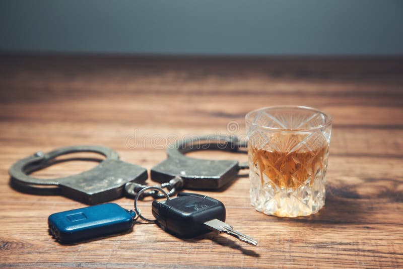 Handcuffes and Car Key with Glass of Drink Stock Photo - Image of ...