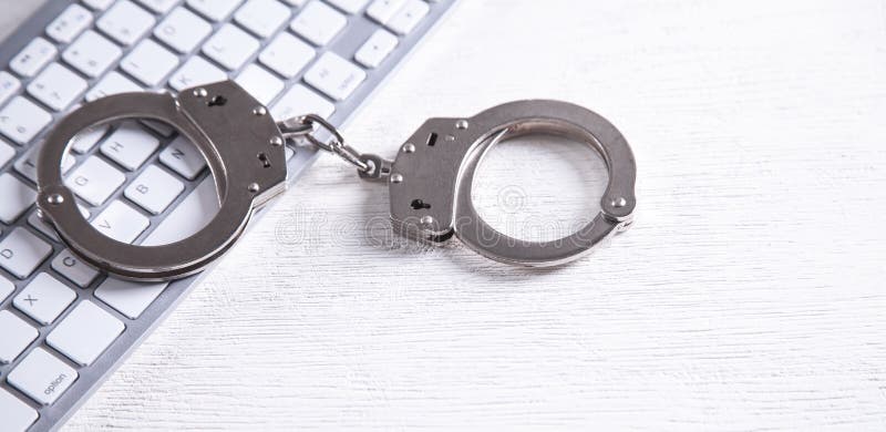 Handcuffs on Computer Keyboard. Concept of Cyber Crime and Online Fraud ...