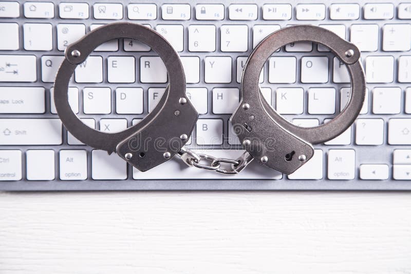 Handcuffs on Computer Keyboard. Concept of Cyber Crime and Online Fraud ...