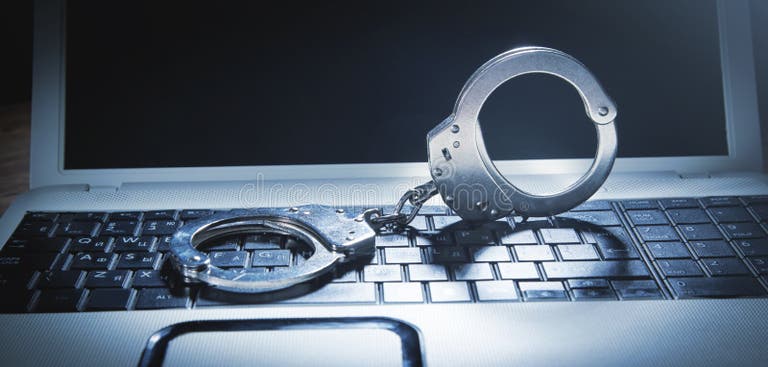 Handcuffs on the Computer Keyboard. Cyber Crime Stock Photo - Image of ...