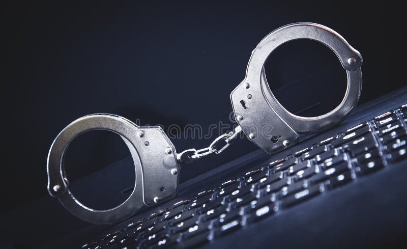Handcuffs on Computer Keyboard. Concept of Cyber Crime and Online Fraud ...