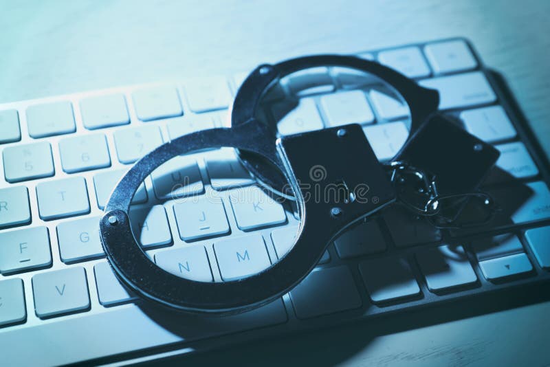 Handcuffs and Computer Keyboard on Table. Cyber Crime Stock Photo ...