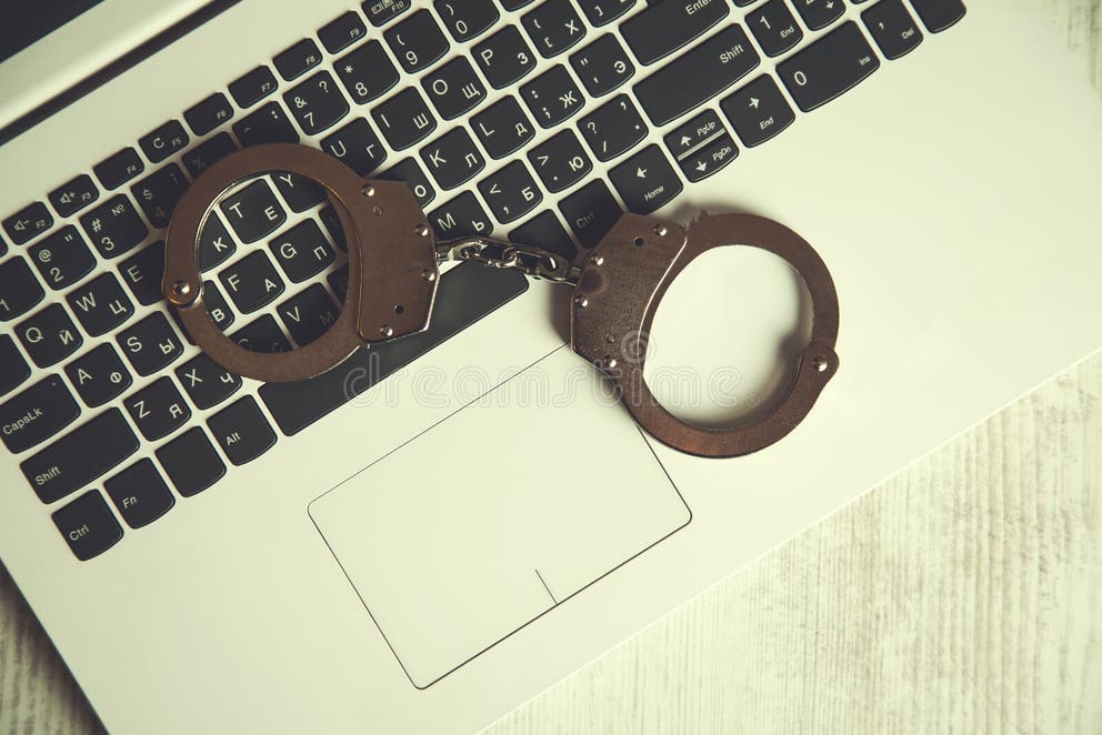 Handcuffs on keyboard stock image. Image of technology - 135378053