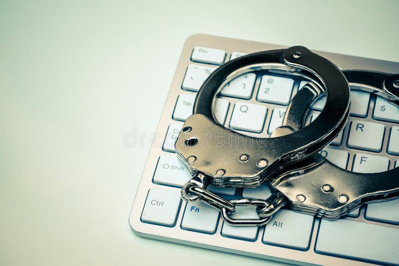 Handcuffs on Computer Keyboard Stock Photo - Image of cyber, hacking ...