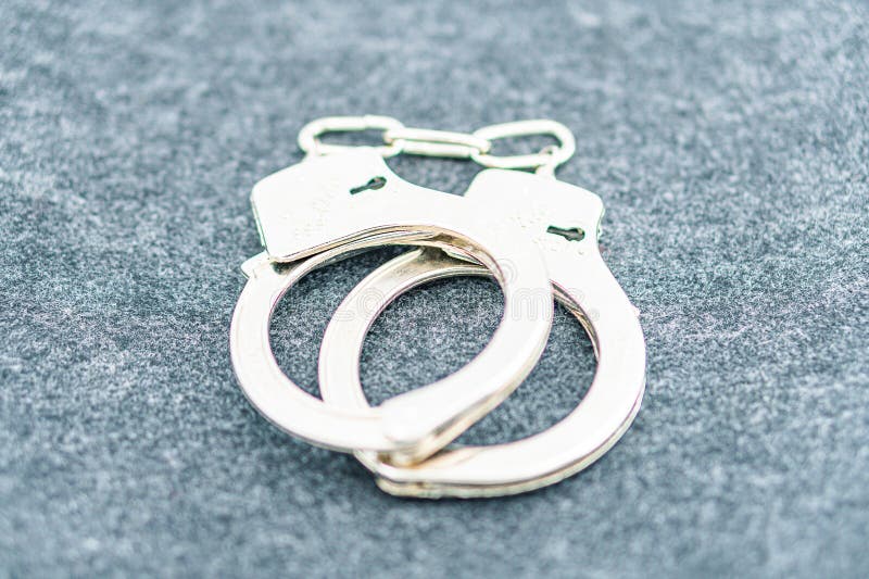 Handcuffs on an Empty Background, Photography. Police Handcuffs on Dark ...